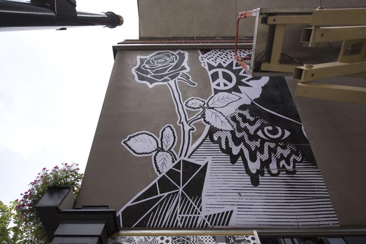 Adam Serrano working on 'Conjuring Giants' mural | | lancasteronline.com