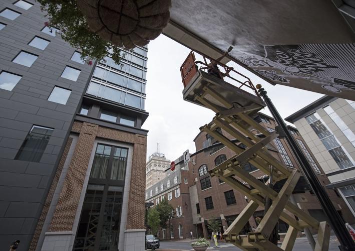 Adam Serrano working on 'Conjuring Giants' mural | | lancasteronline.com