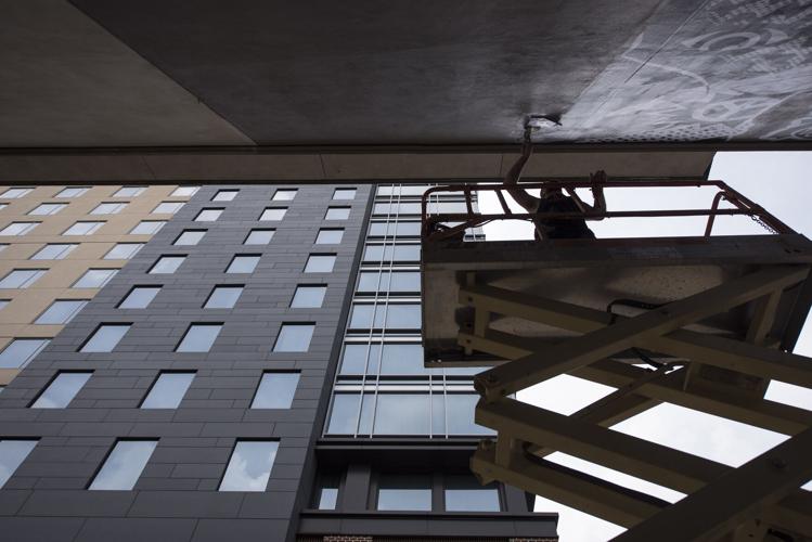 Adam Serrano working on 'Conjuring Giants' mural | | lancasteronline.com