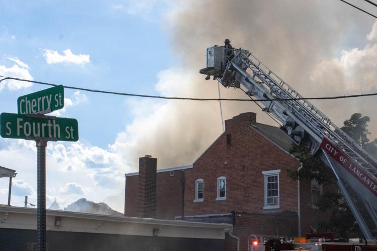 Fire crews battle 3-alarm fire that tears through block of downtown ...