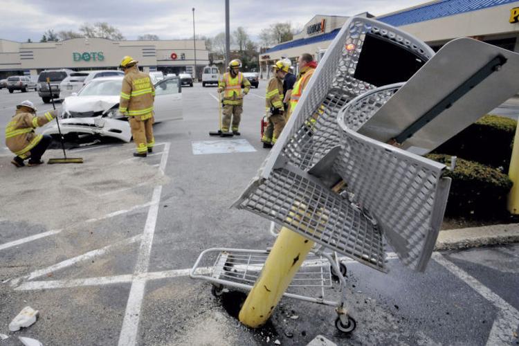 Car crashes into car, shopping cart and post in parking lot | News ...