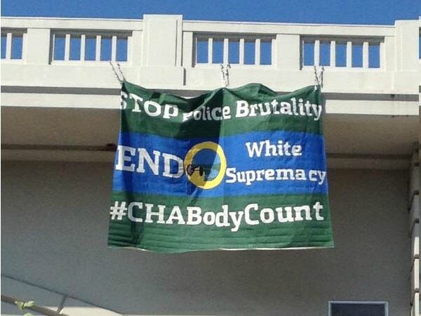 Controversial sign coincides with police brutality rally | What's ...