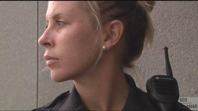Kelly Downs wears both CFC jersey and CPD badge | | local3news.com