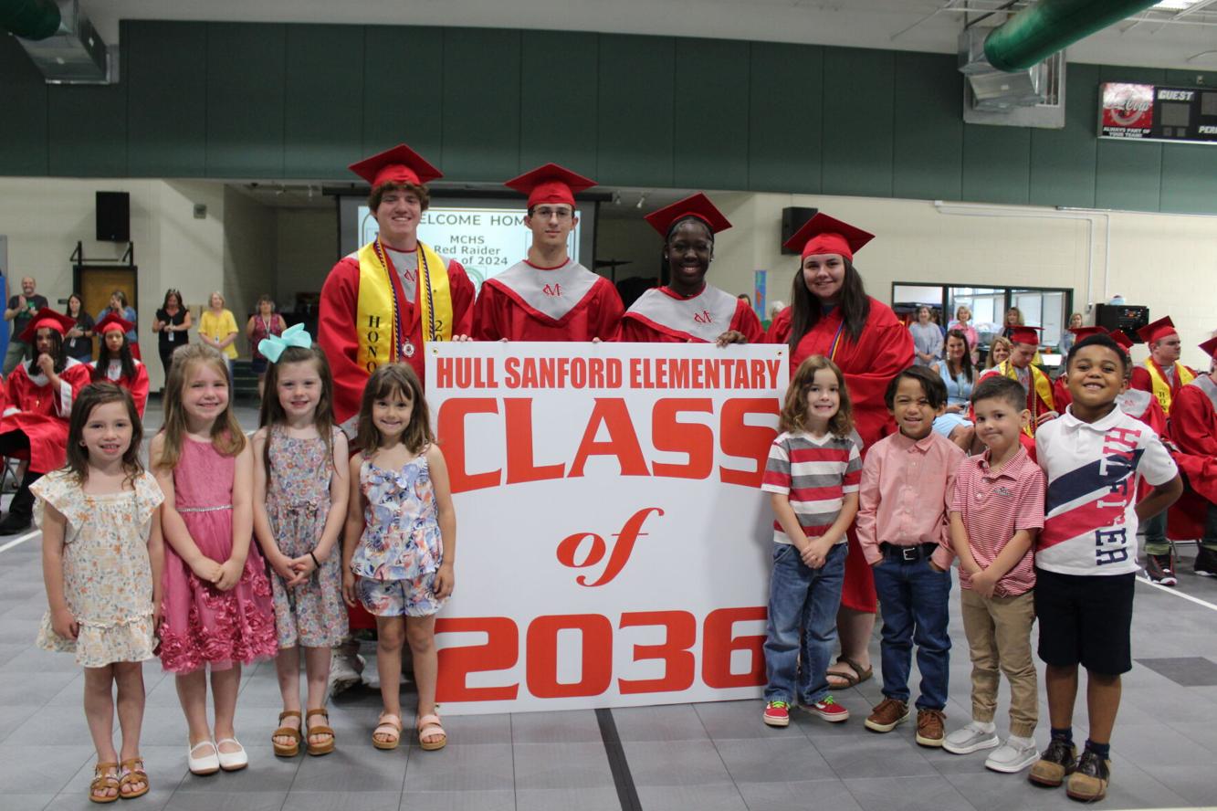 Kindergarten Citizenship recipients accept the Class of 2036 sign at ...