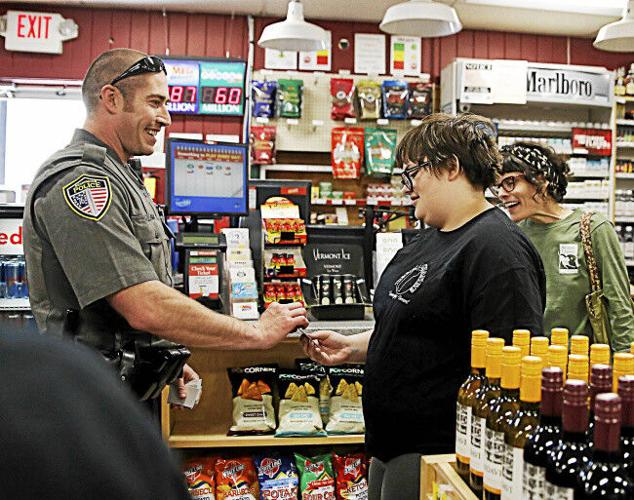Youth place warning stickers on alcoholic beverage cases for 'Sticker ...