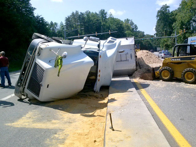 Tractor-trailer turning onto U.S. 220 overturns