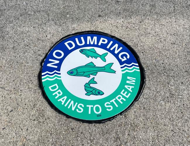 Permanent storm drain markers uptown