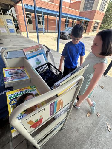 Graves County kids choose free books at meal pickup site | News ...