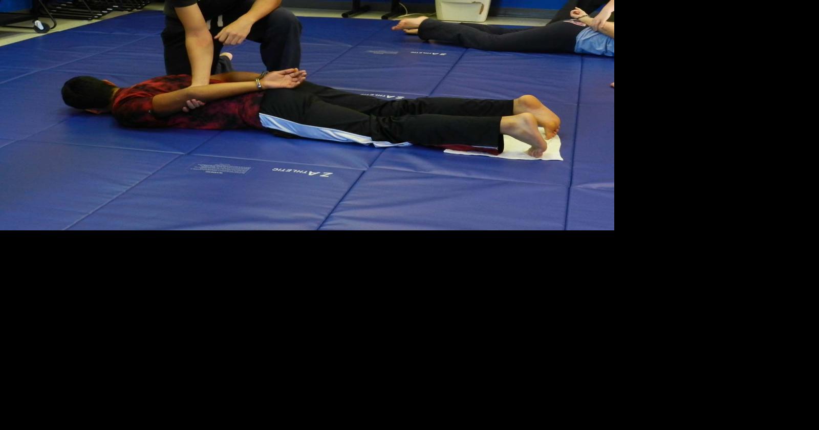 Law and Justice students practice handcuff techniques