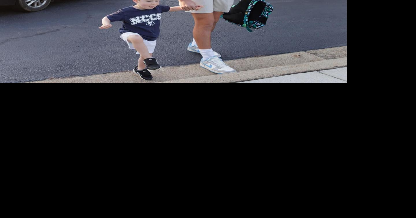 NCCS football players help kindergartners to class | Education ...