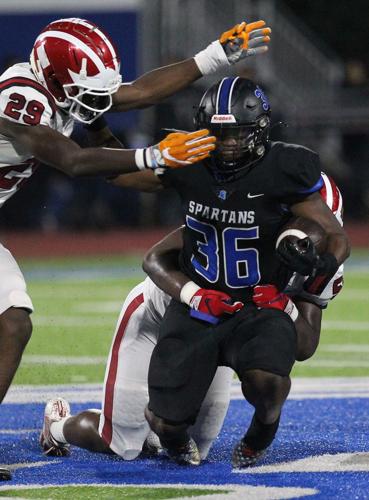 Hillgrove Hawks junior DL Nick Mathious (54) and sophmore DL Chris Carbin (29) records a big ...