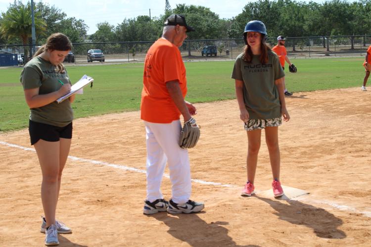 Softball players surprise local coach with award ...