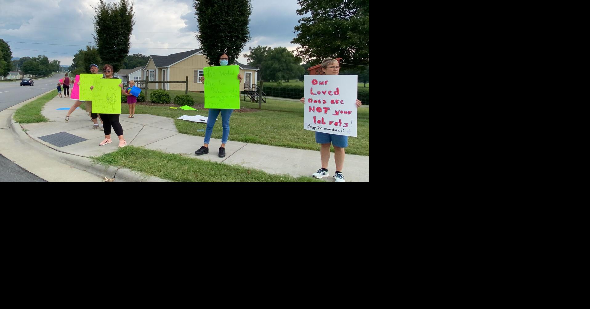 Employees gather outside facility to protest vaccine policy