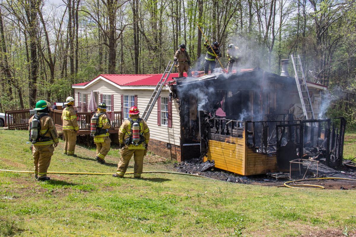 Storage building fire damages home