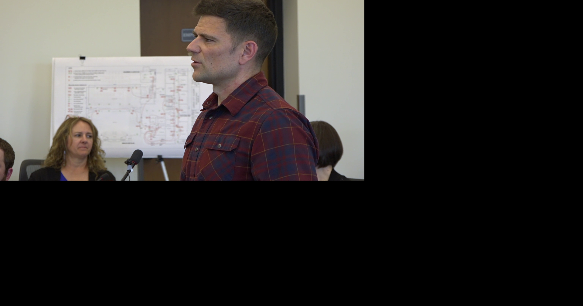 Kyle Strong, executive pastor of Grace City Church, addresses a public ...