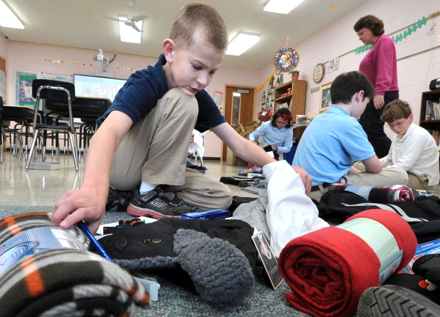 Holy Cross youths fill backpacks to be given this week to those in need ...