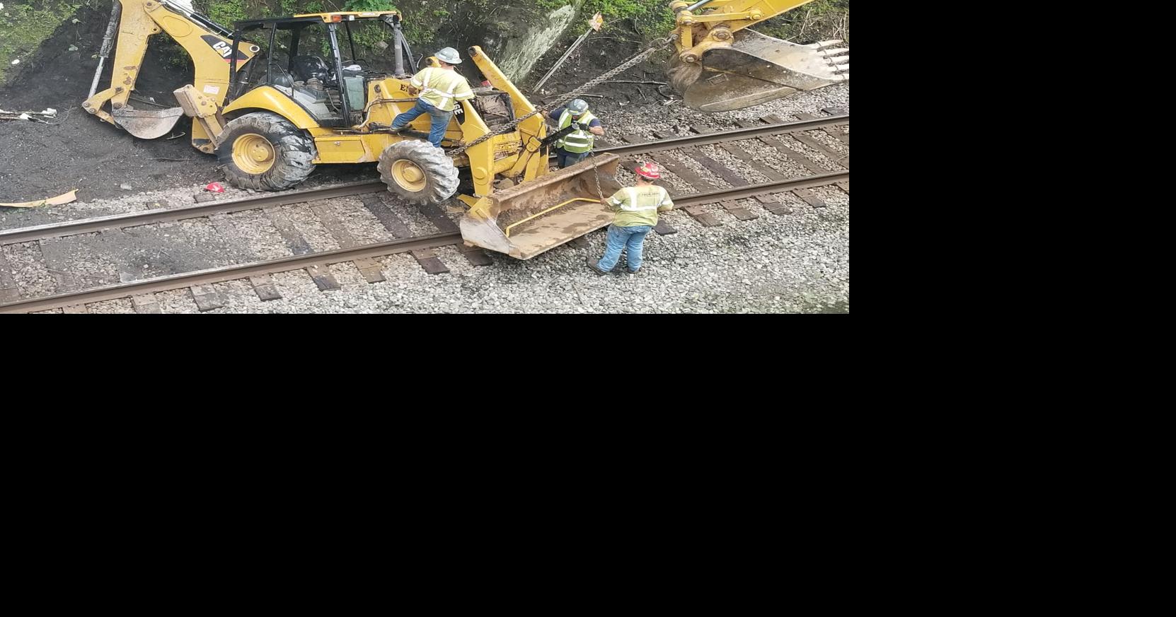 Backhoe driver survives fall onto active train track in Forest