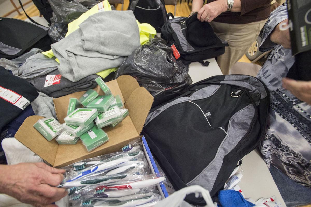 Affordable housing residents lend a hand, fill cold-weather backpacks ...