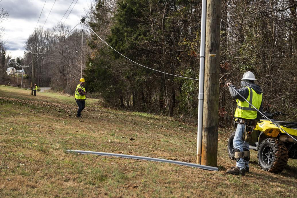 Crews work to install fiber-optic cable, allowing high-speed internet ...