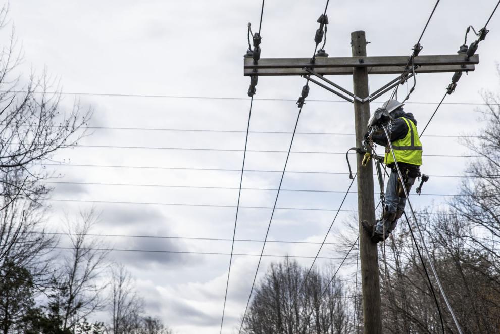 Crews work to install fiber-optic cable, allowing high-speed internet ...