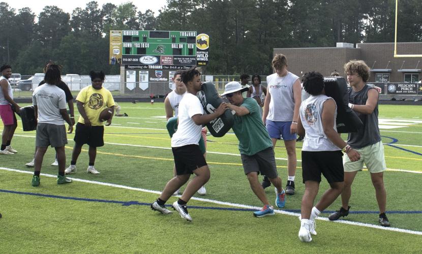 Trojan football getting early start installing new offense, defense and ...