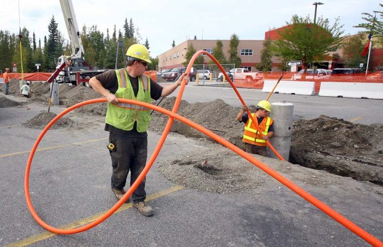 Crews installing outlets for car heaters in West Valley High School ...