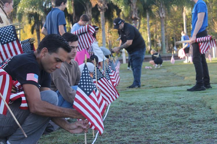PHOTOS: Honoring our veterans: Planting American flags into Memory Mall ...