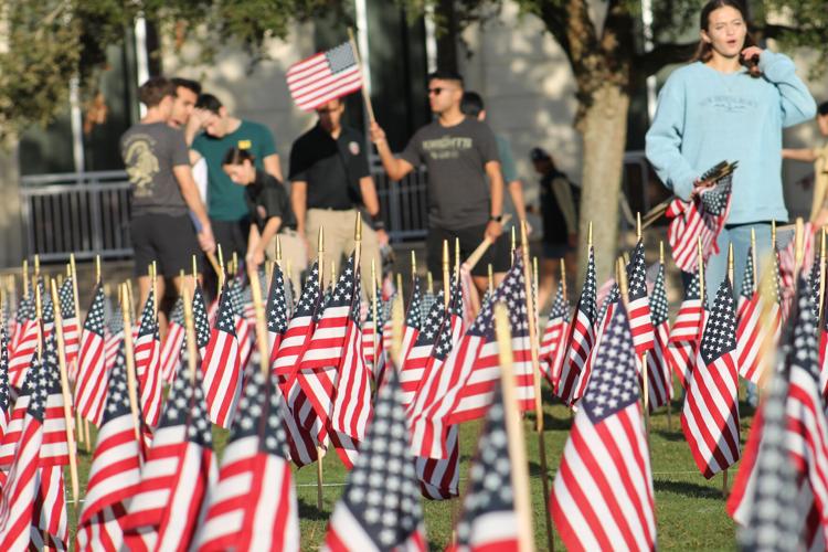 PHOTOS: Honoring our veterans: Planting American flags into Memory Mall ...