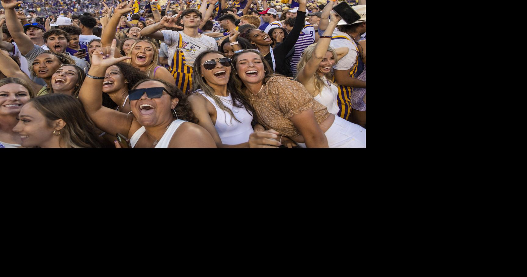 LSU fans rushed the field after the Ole Miss win. Some watching were ...