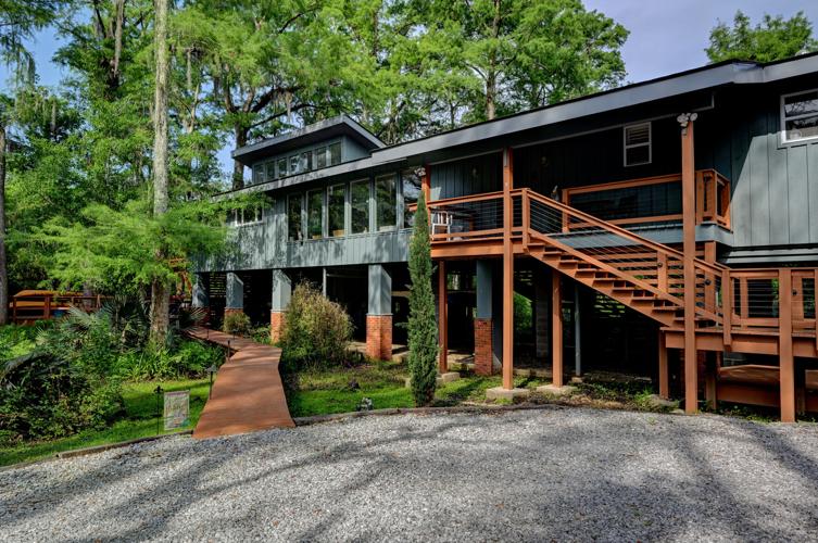 Tucked away on a bayou yet close to Old Mandeville, this home is an ...