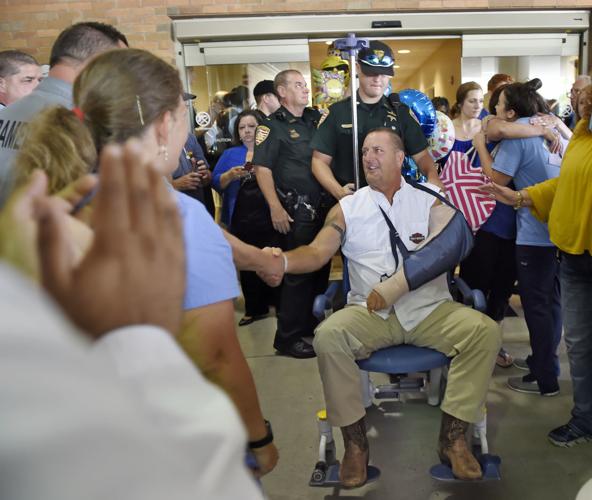 Photos, video: Huge ovation for deputy Bruce Simmons as he's released ...
