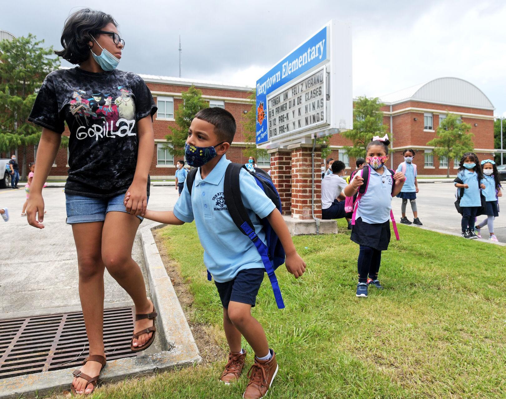 Photos: Parents welcome students after they attend the first day of class at Terrytown ...