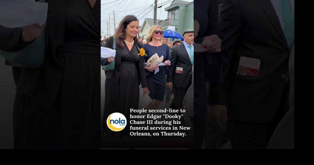 People gather for a second-line to honor Edgar "Dooky" Chase III during ...