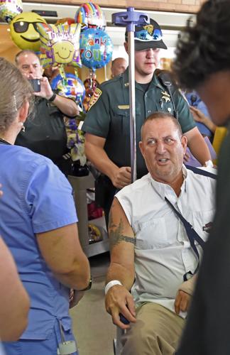 Photos, video: Huge ovation for deputy Bruce Simmons as he's released ...