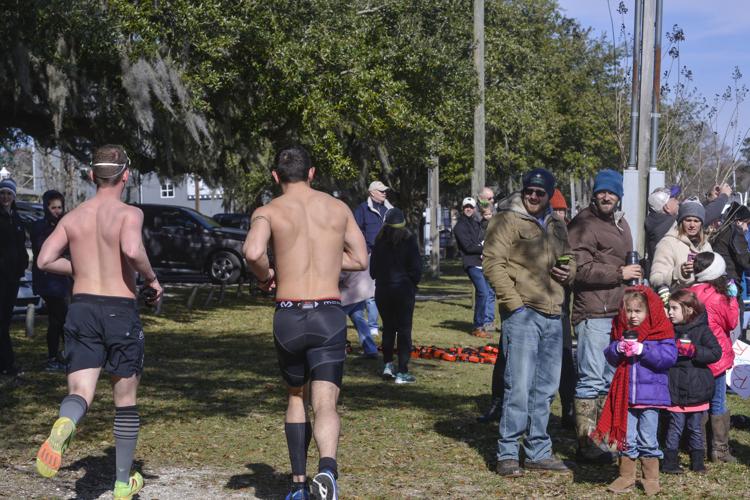 Dozens brave subfreezing temps to swim across Tchefuncte River in ...