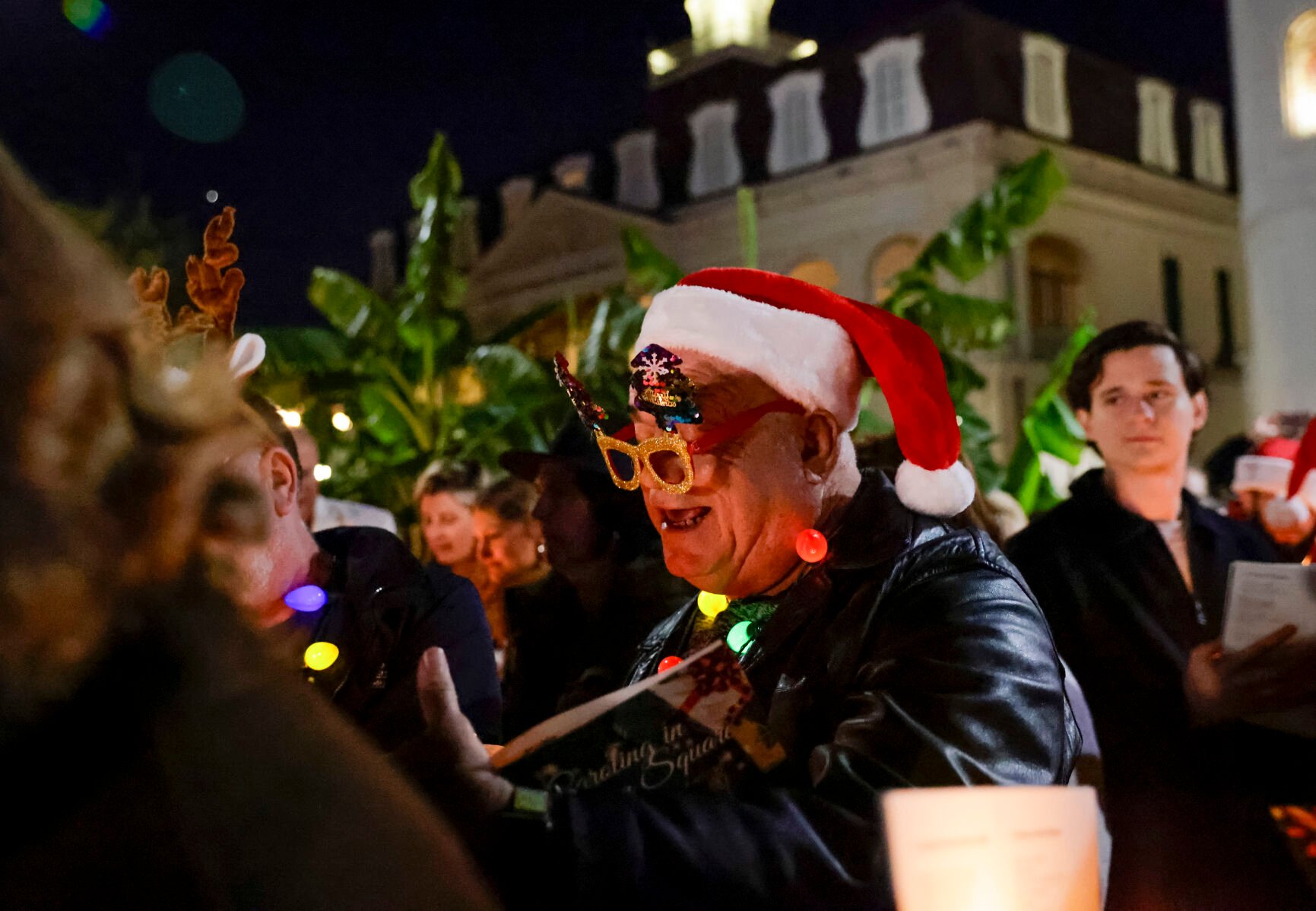 People gather on a crisp night to carol in Jackson Square ...