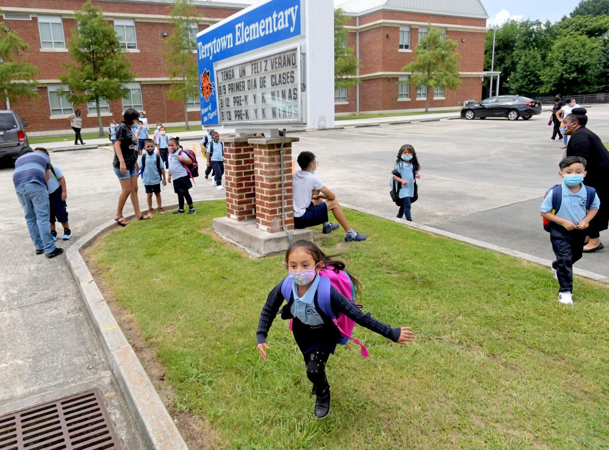 Photos: Parents welcome students after they attend the first day of class at Terrytown ...
