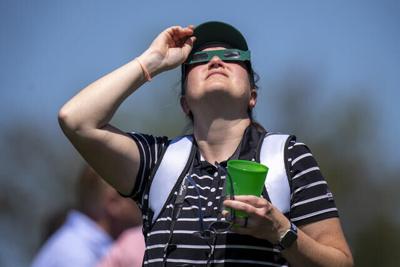 Masters goers look skyward Monday during partial eclipse | Sports ...