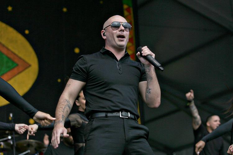 Rapper Pitbull hosted a sweaty dance party at the New Orleans Jazz Fest ...