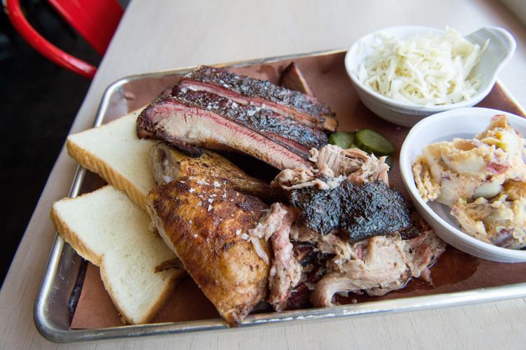 Change at the smoker at Central City BBQ, and shifting coals in a ...