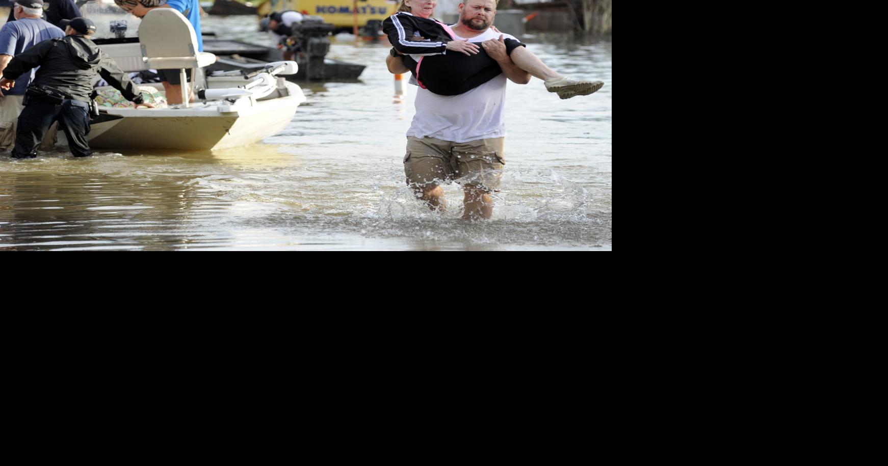 Photos: Historic flooding causes road closures, widespread damage in ...