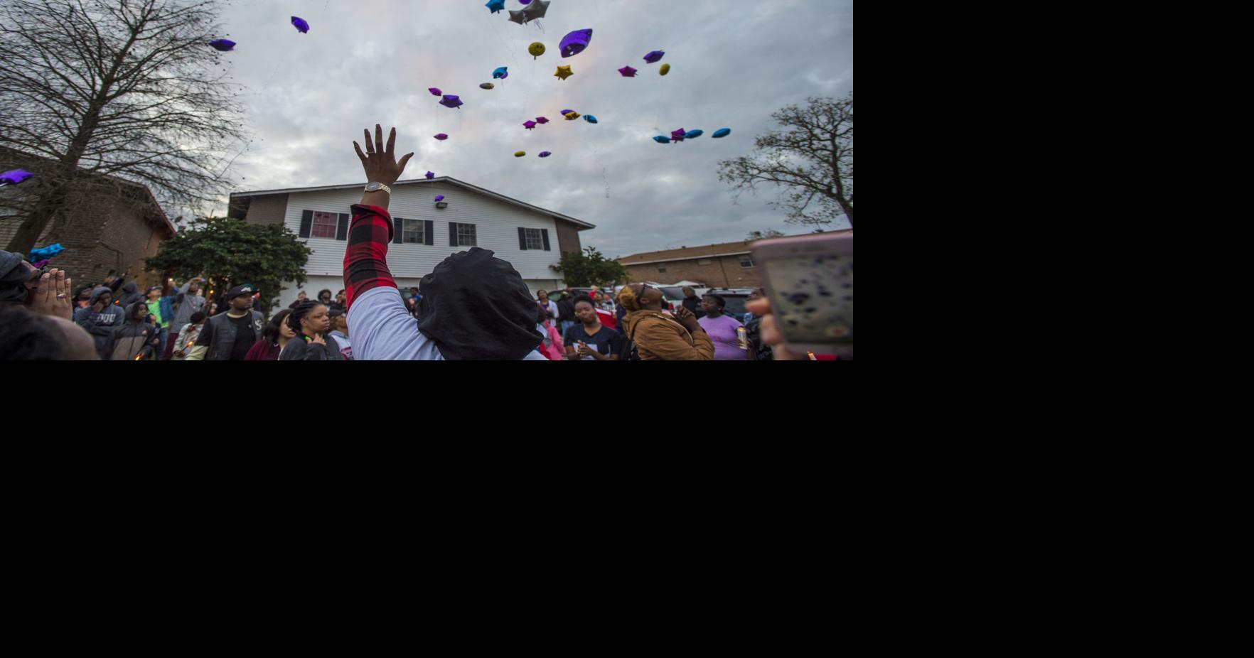 Photos: Family and friends gather for a vigil honoring the three people ...