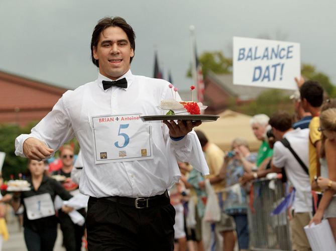 Bartenders and servers race at the Bastille Day fete, San Fermin's El ...