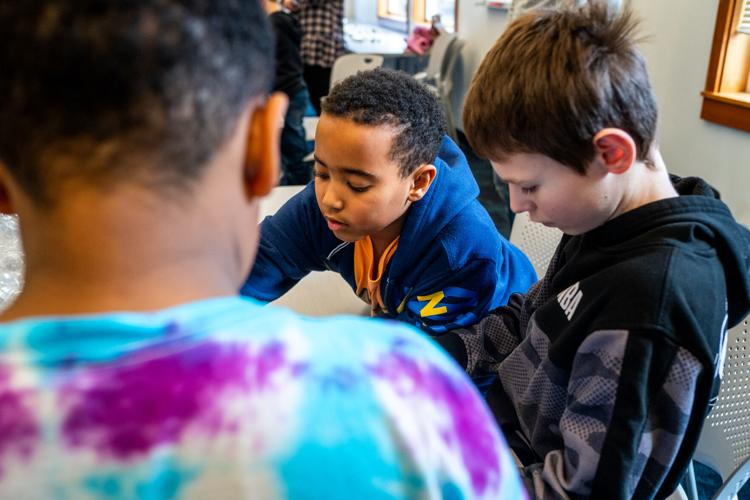Children pack into Roseburg Public Library for ornament crafting ...