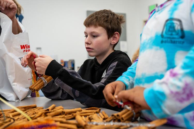 Children pack into Roseburg Public Library for ornament crafting ...