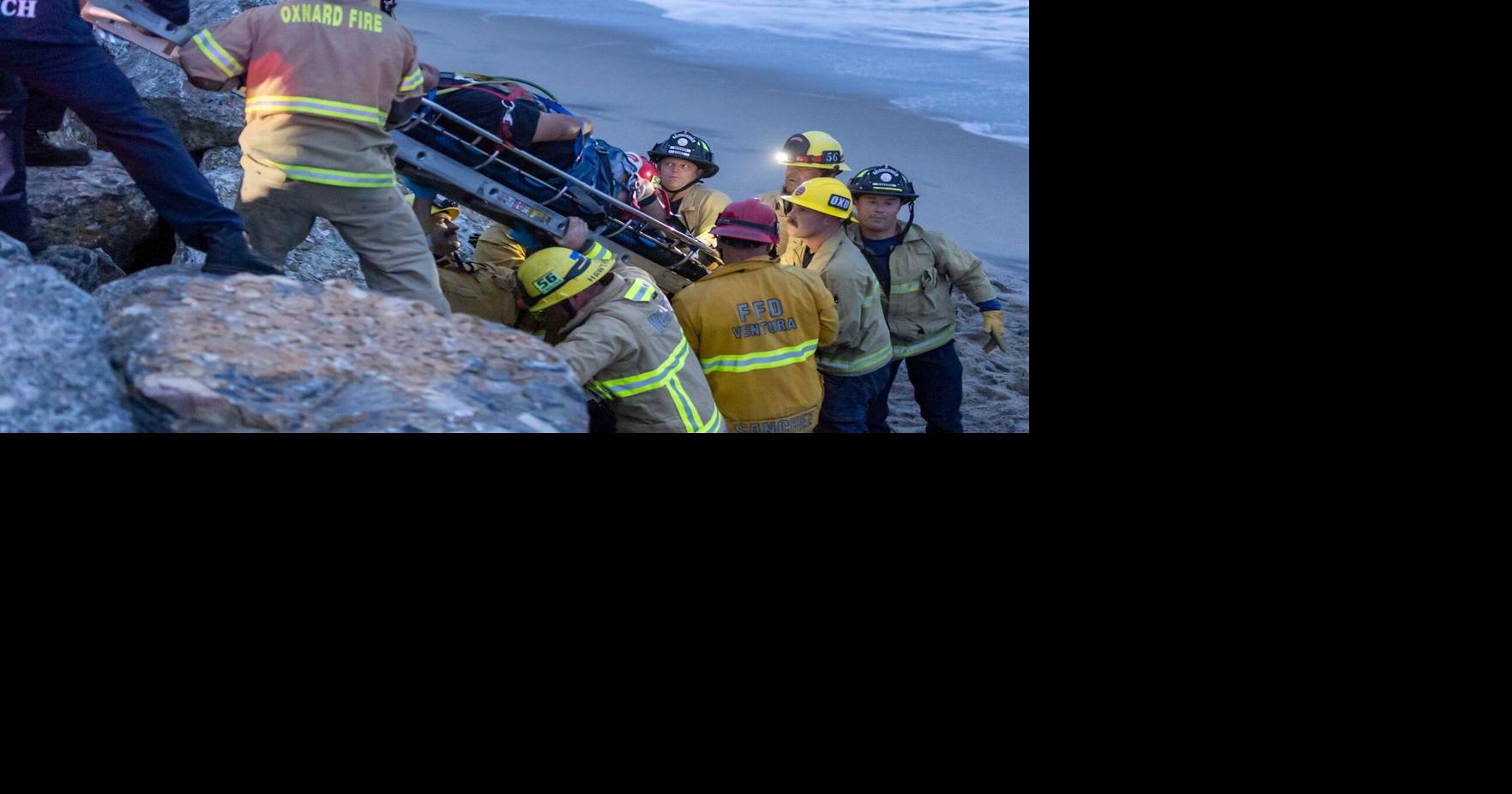 Rescuers free person trapped by large rock along Pacific Coast Highway ...