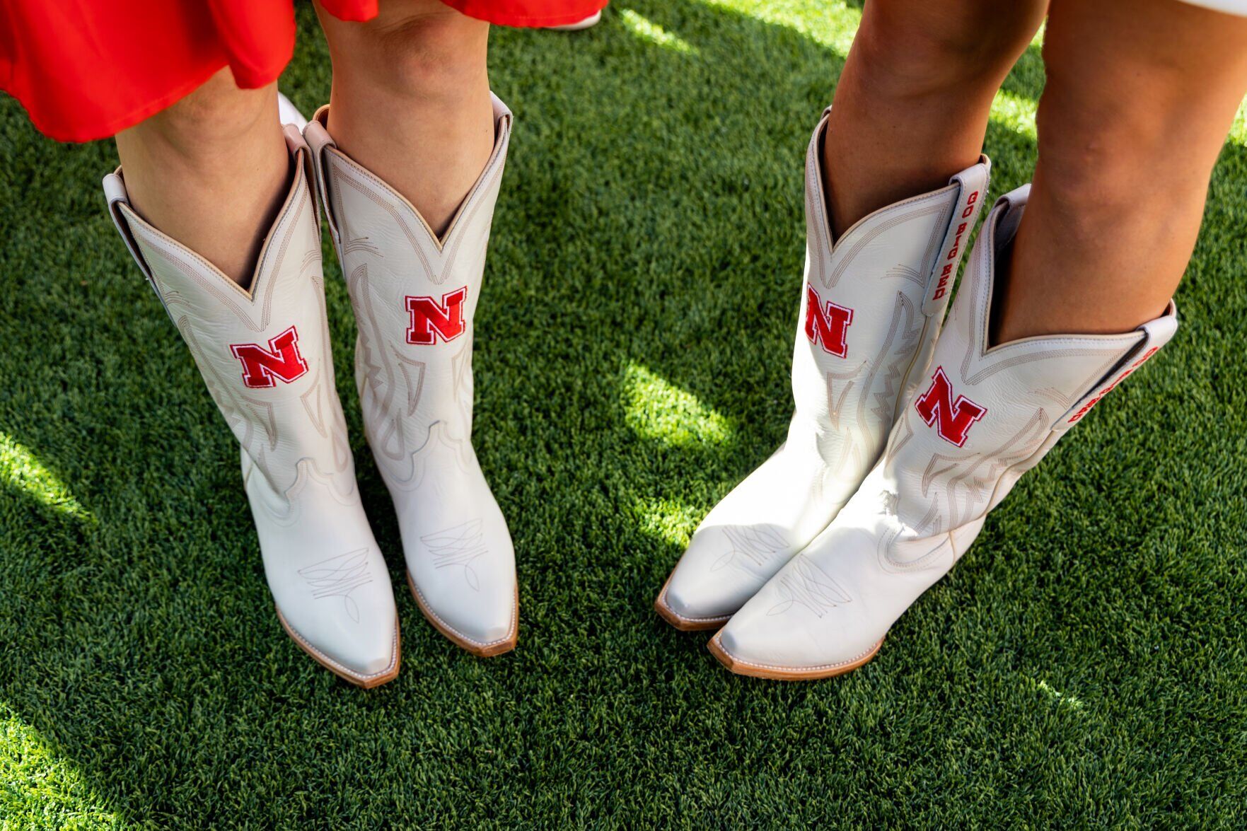 Dallas Cowboys cheerleaders help with Husker Scarlets' routine