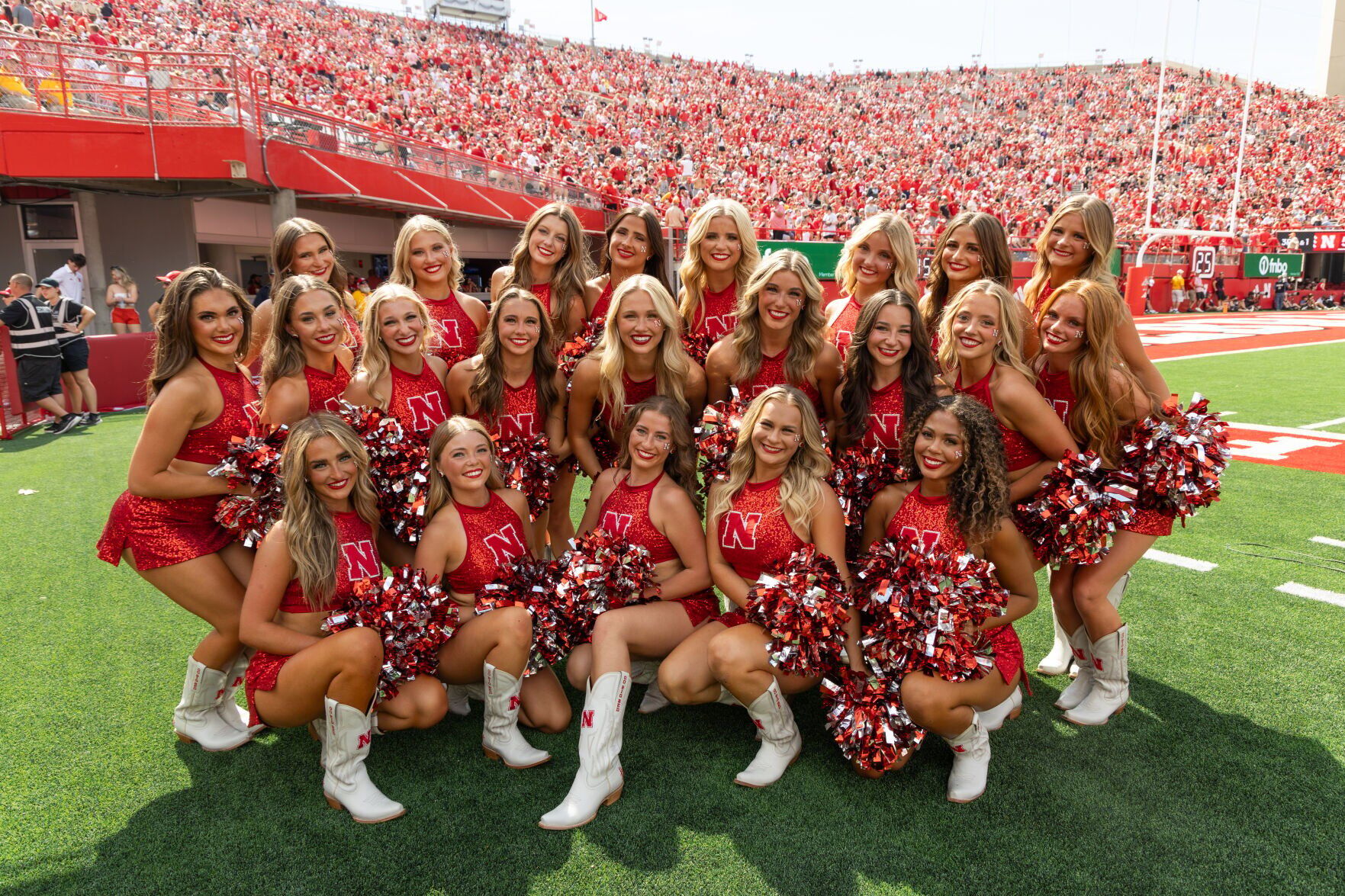 Dallas Cowboys cheerleaders help with Husker Scarlets' routine