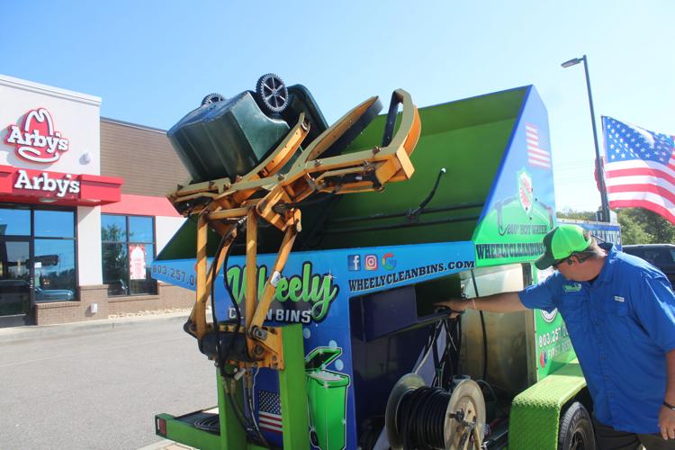 North Augusta firefighter cleans trash bins with care