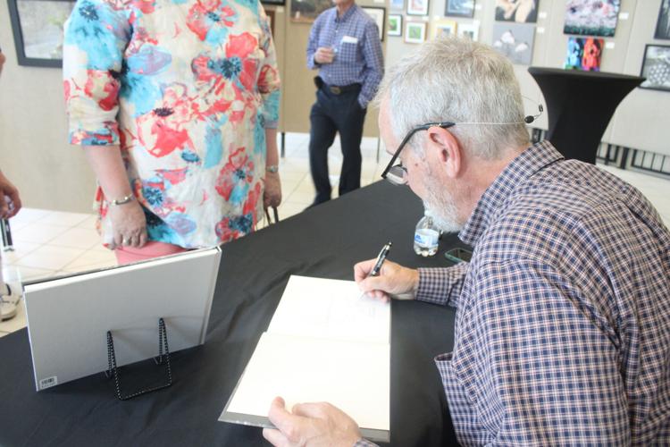 Photography reception features local photos and book signing